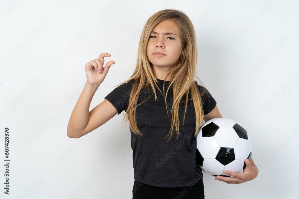 Displeased beautiful caucasian teen girl wearing sportswear over white ...