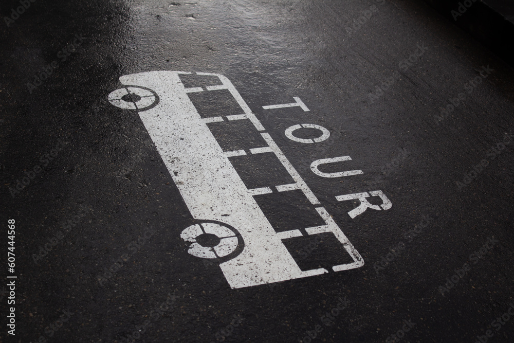 Road sign on wet asphalt. Road sign with the image of a city tourist ...
