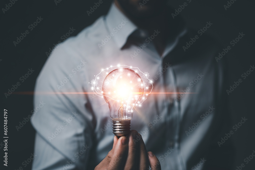 Hand of Man holding light bulb on dark blackground. Idea innovation and ...