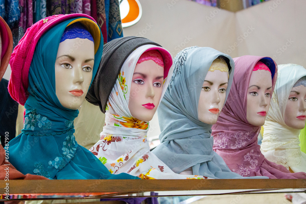 Mannequins wearing different colors and fashions hijab and headscarf is ...