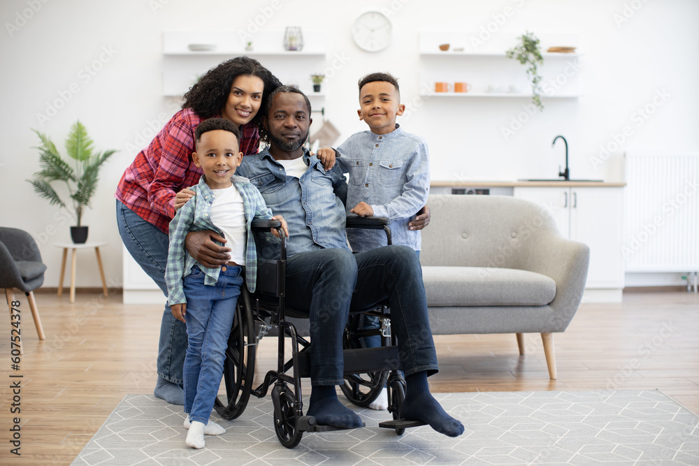 Full length portrait of happy multicultural family of four hugging each ...