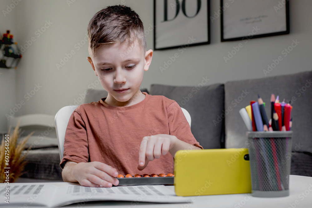 Little preschooler counting large numbers on his fingers using mental ...
