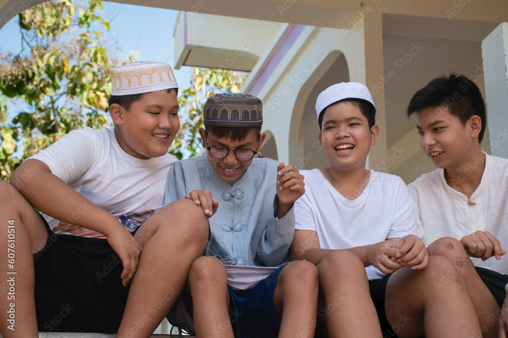 Group of young asian muslim boys sit together, they are waiting to join ...