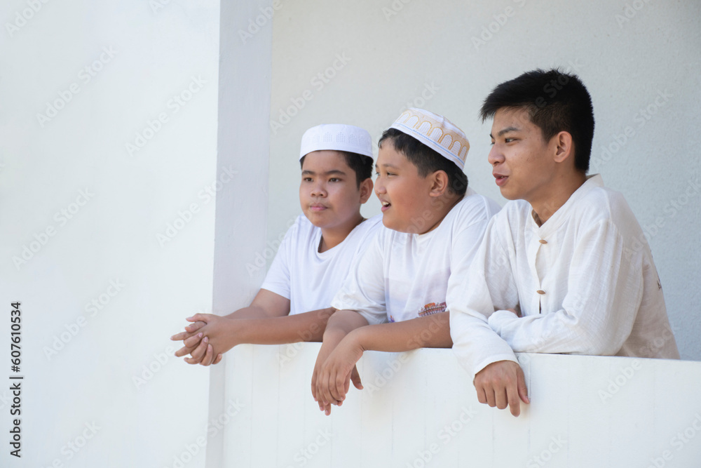 Group of young asian muslim boys stand together, they are waiting to ...