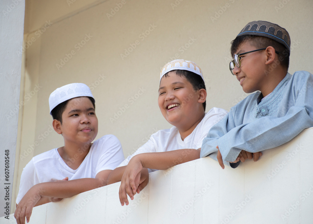 Group of young asian muslim boys stand together, they are waiting to ...