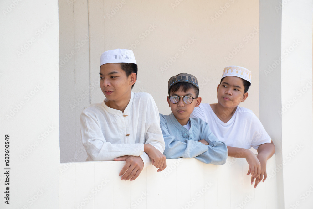 Group of young asian muslim boys stand together, they are waiting to ...