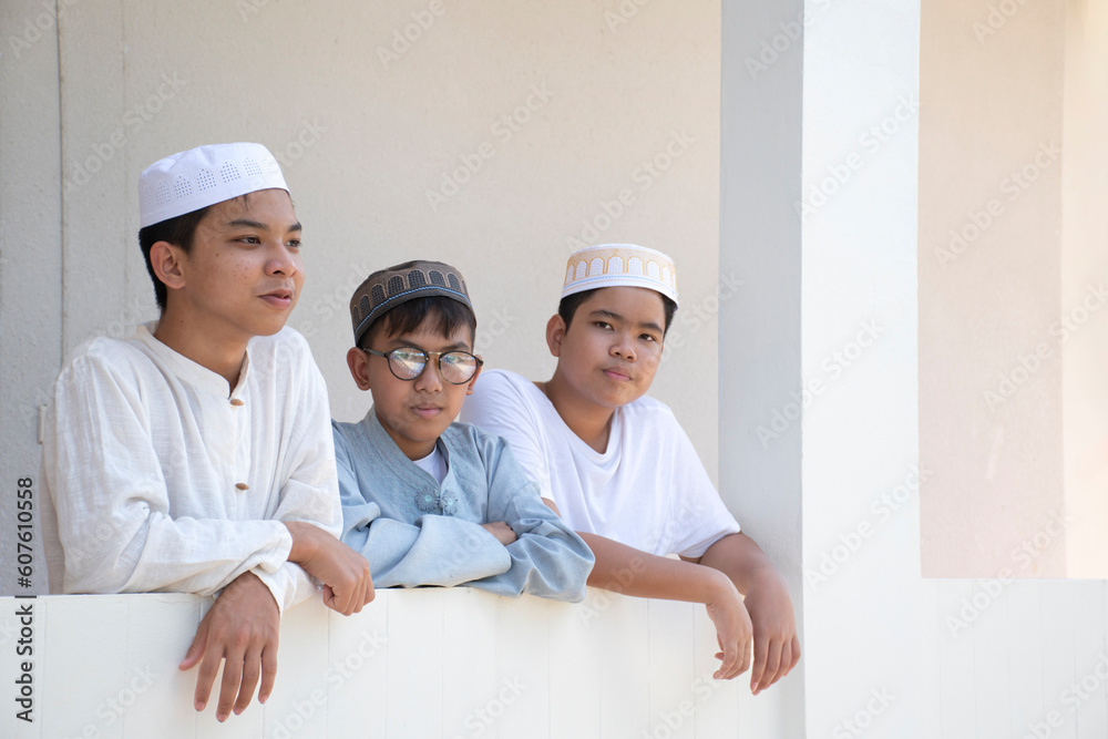 Group of young asian muslim boys stand together, they are waiting to ...