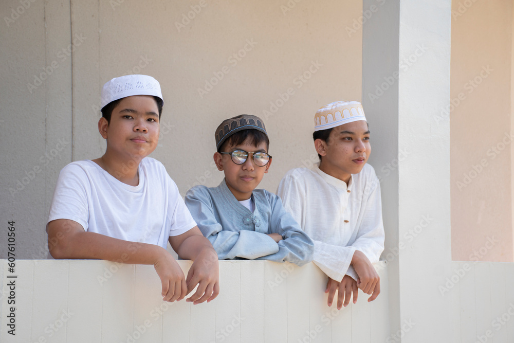 Group of young asian muslim boys stand together, they are waiting to ...