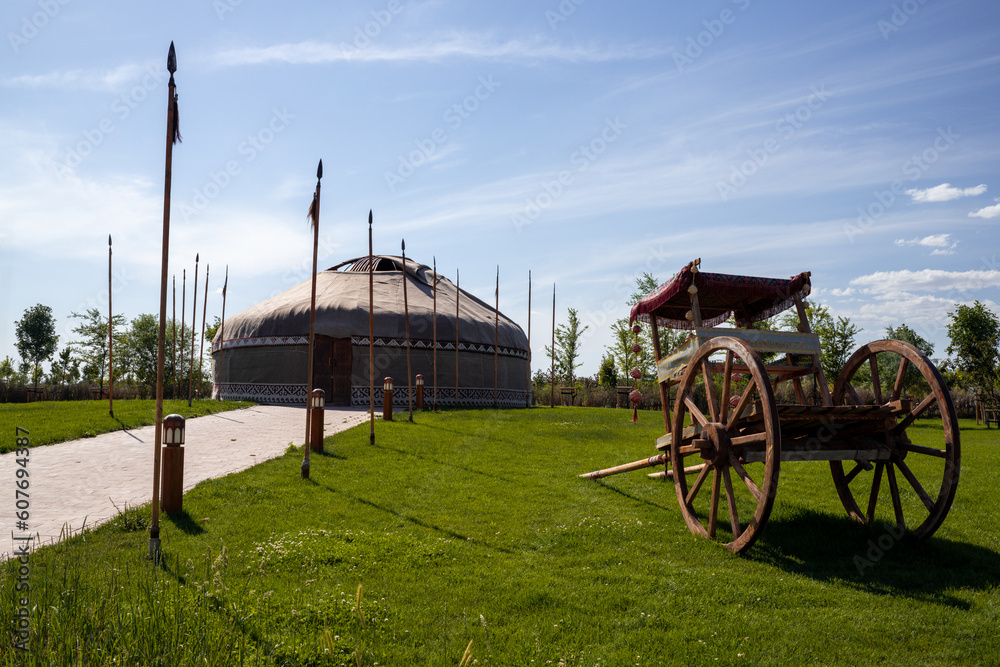 Traditional Kazakh yurt and cart with large wheels that could easily ...
