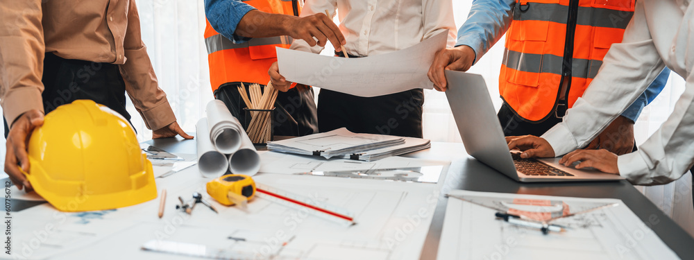 Engineer partner drawing and working on blueprint design together on ...