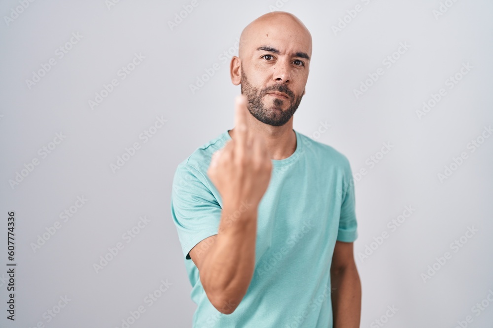 Middle age bald man standing over white background showing middle ...