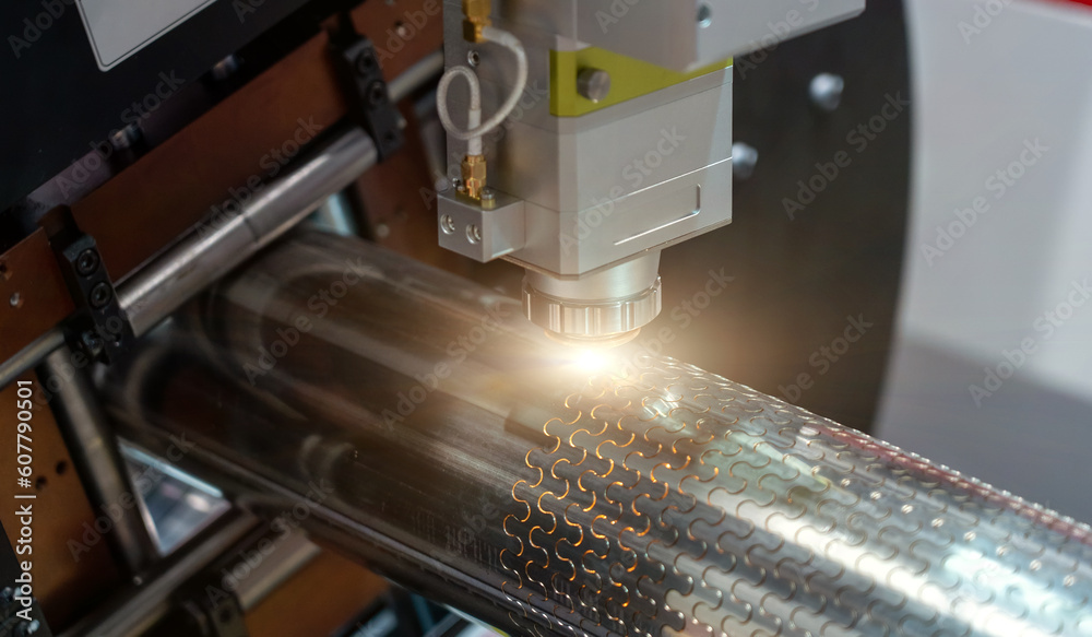 CNC laser cutting machine cuts uniform wavy lines pattern in a ...