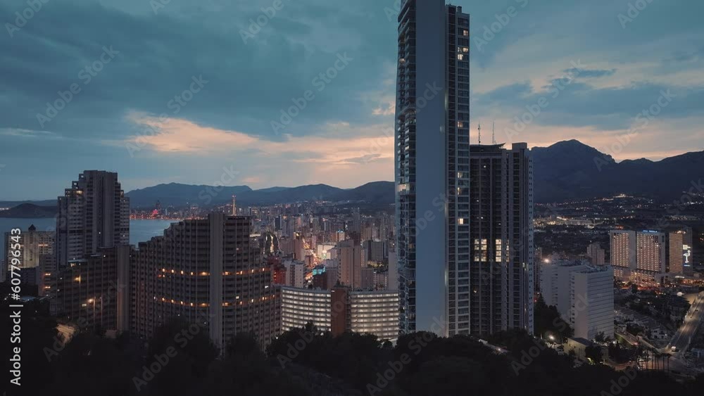 Bright seafront city with modern architecture in the evening. Pink ...