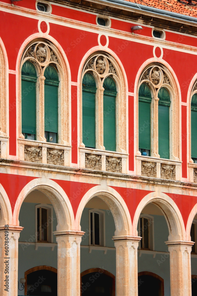 Picturesque windows on historic red building facade in Split, Croatia ...