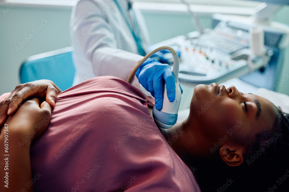 Stockfoto Black woman during ultrasound thyroid gland examination at ...