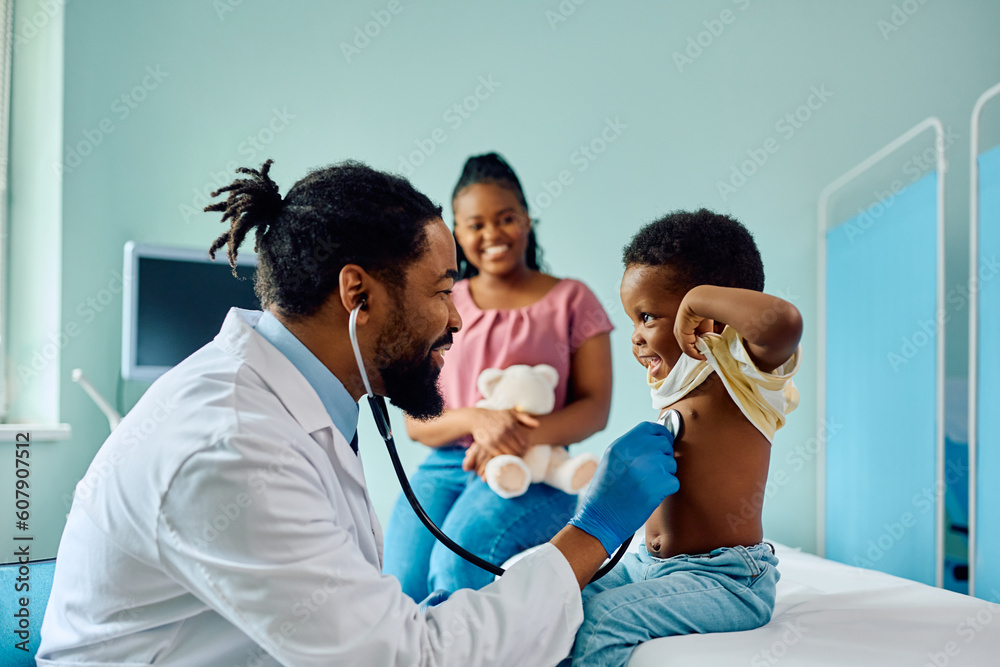 Happy black kid during medical examination at doctor's office. Stock ...
