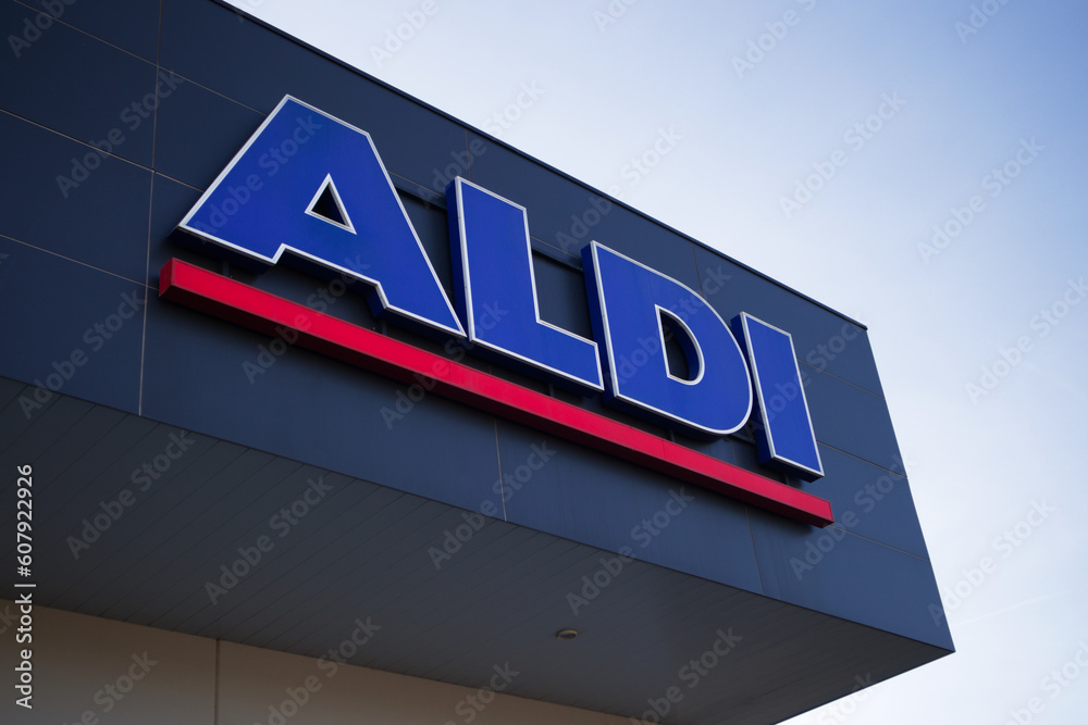 Aldi supermarket logo on one of its stores with blue sky in the ...