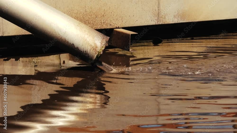 Water pollution in nature. Dirty water flows into the river through a ...
