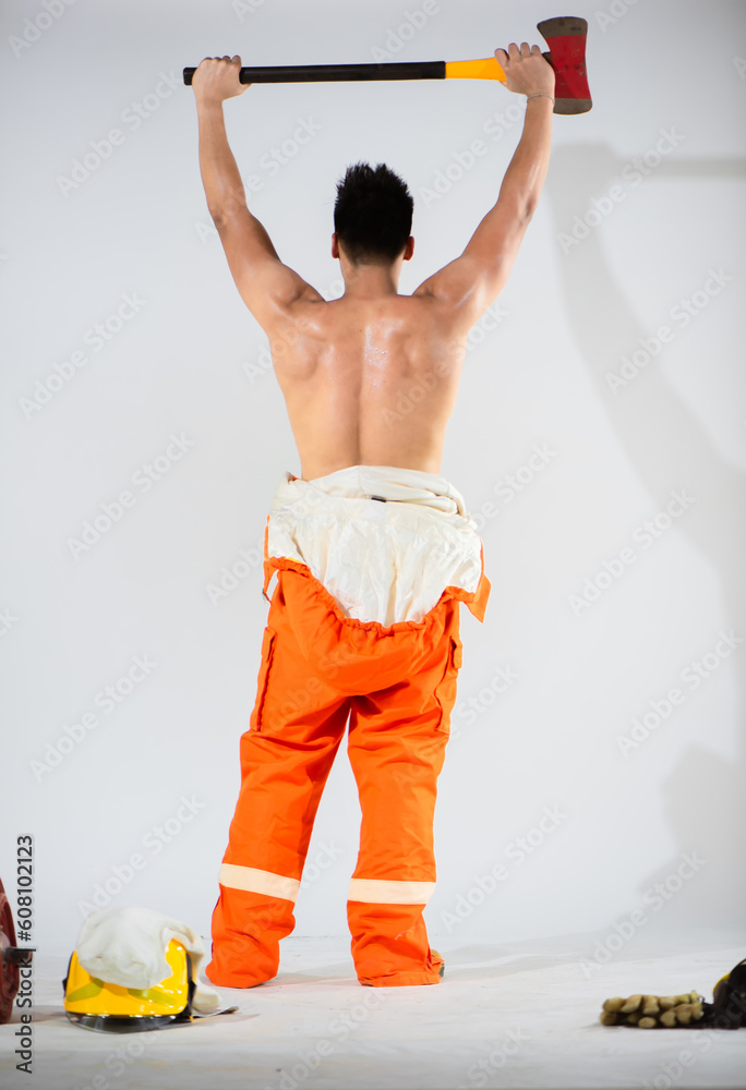 From a back view perspective the professional firefighter stands and ...