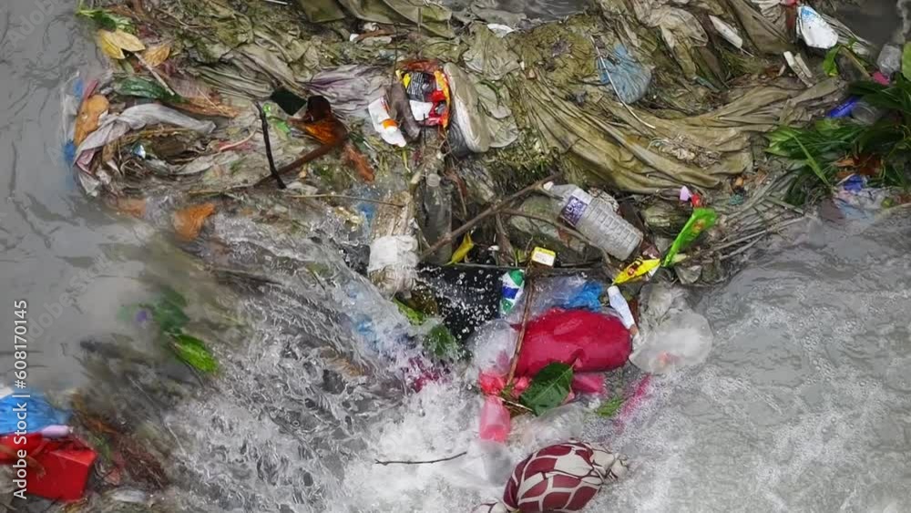 plastic bottles and bags in the river vertical video. plastic pollution ...