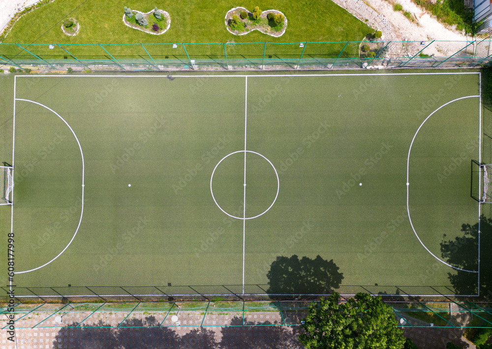 From an aerial perspective, an empty football field comes into view ...