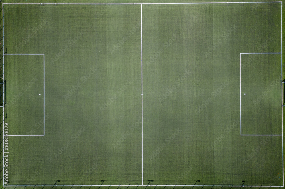 From an aerial perspective, an empty football field comes into view ...