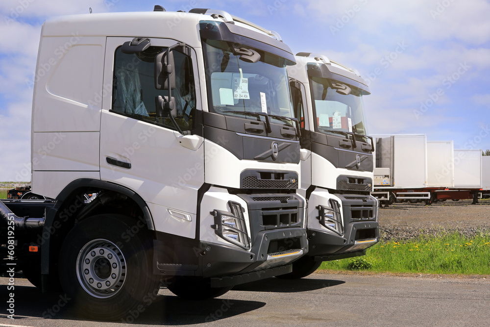 Two New, White Volvo FMX Construction Trucks Parked, Front/Side View of ...