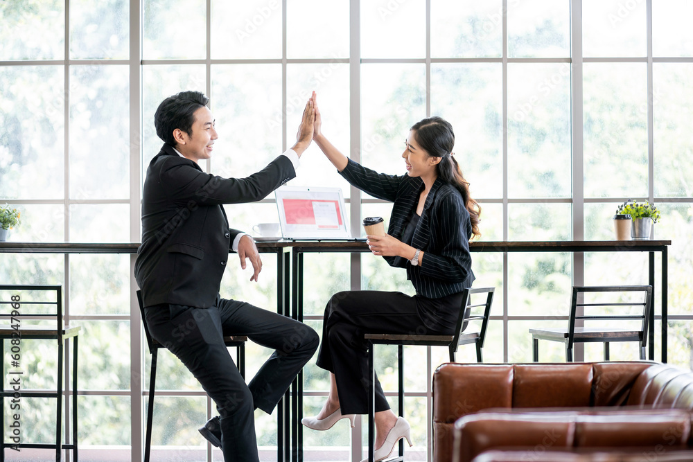 A happy, beautiful and smart Asian businesswoman celebrates by making ...