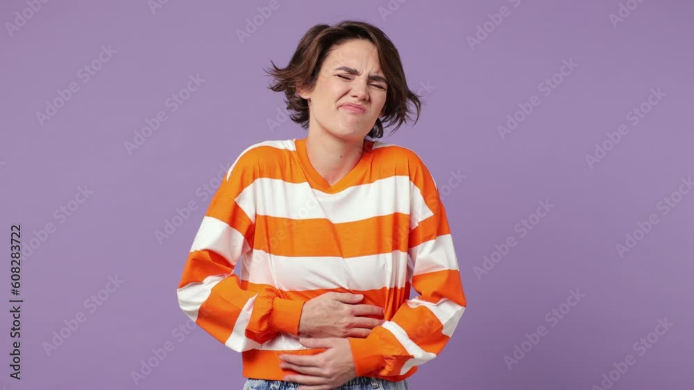 Sick ill sad tired young woman wear casual clothes put hands on abdomen ...