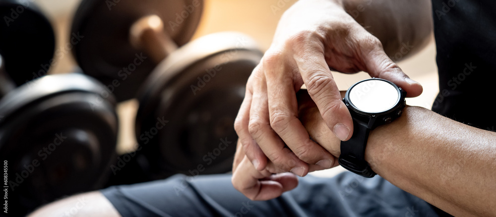 Sport man checking workout result on smartwatch app after weight ...