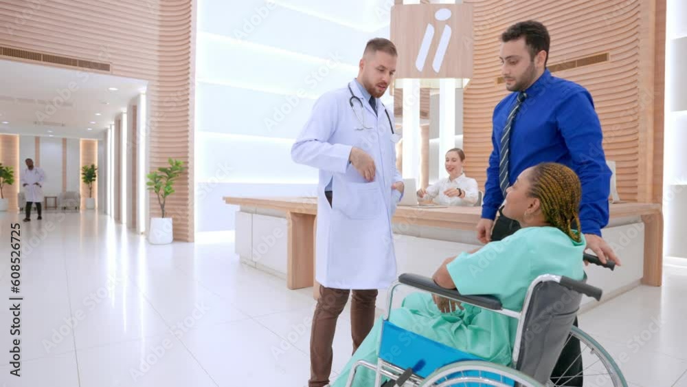 Attractive doctor walk through the hallway to visit patient in hospital ...