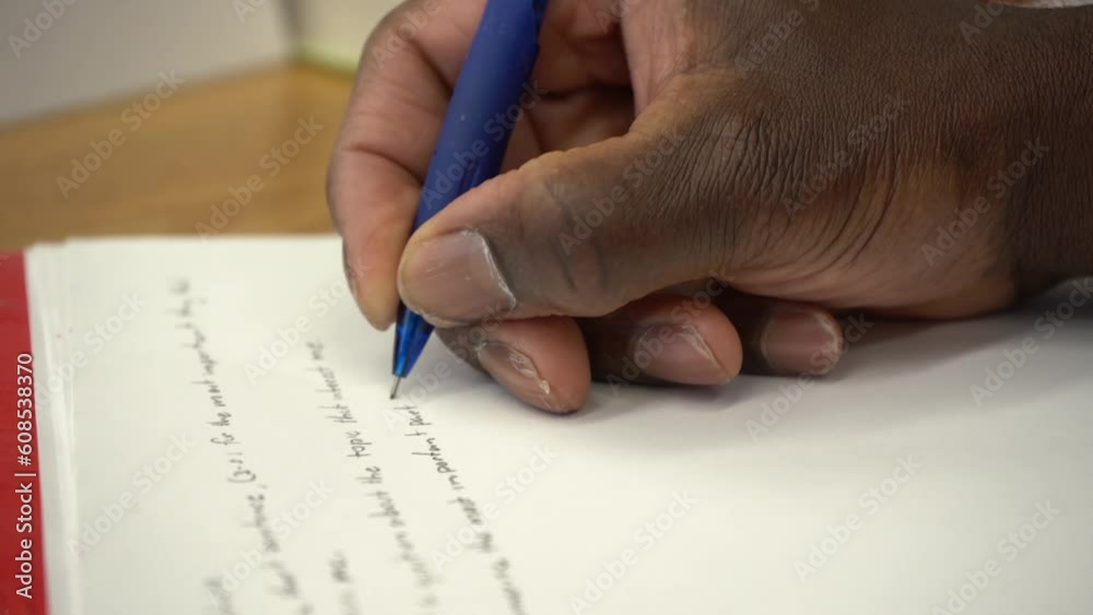 close up african american writing in prison black inmate in jail ...