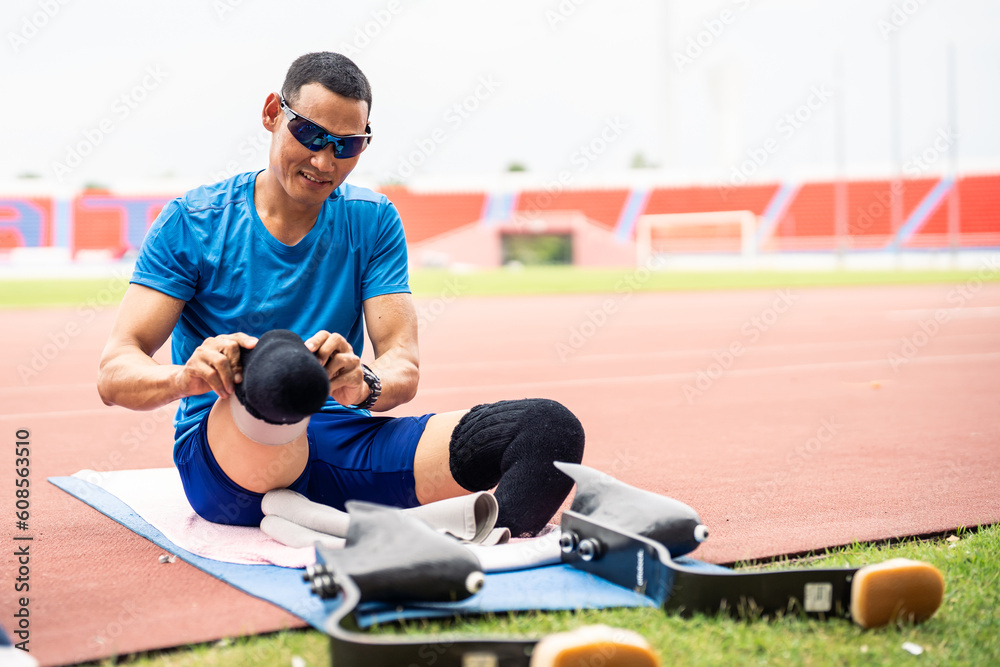 Asian para-athlete disabled wearing prosthetic blades at the stadium ...