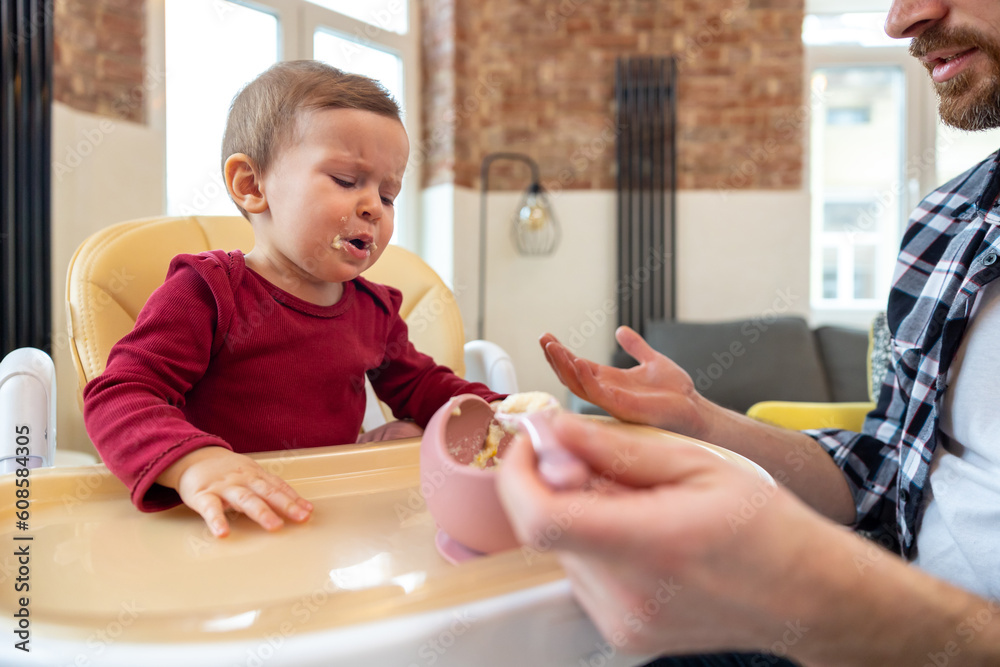 Foto de Infant little baby girl crying and don't want to eat food from ...