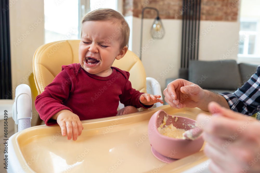 Infant little baby girl crying and don't want to eat food from her ...