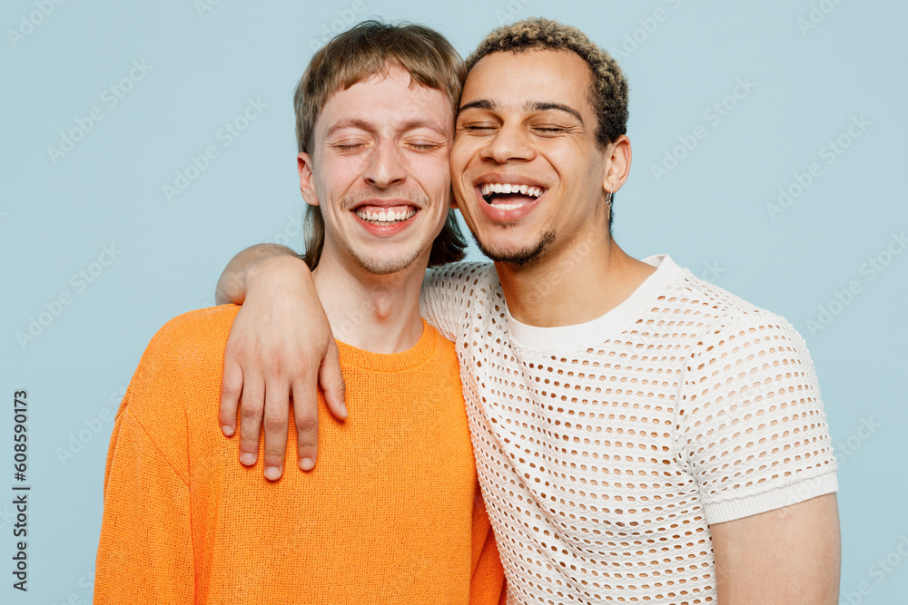 Young smiling happy couple two gay men wear casual clothes together hug ...