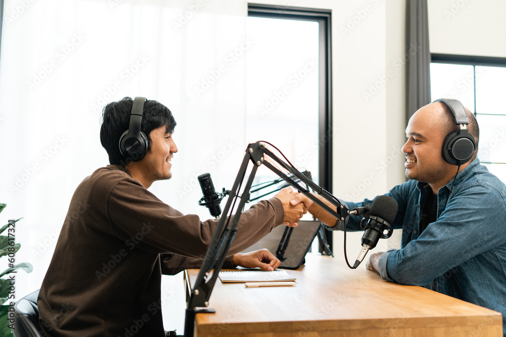 Young asian man host streaming podcast with condenser microphone work ...