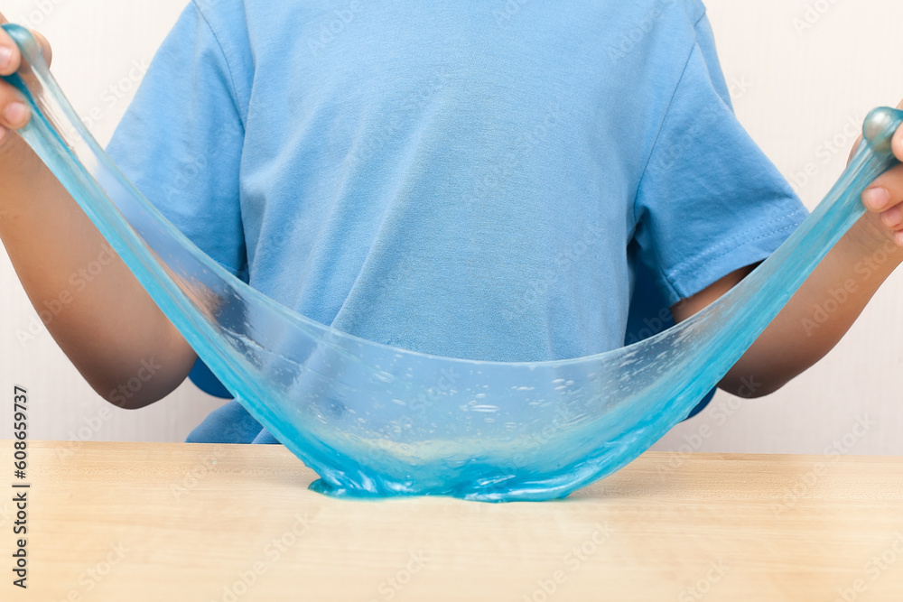 Kid plays with a radiation slime filled with tiny foam beads. Boy ...
