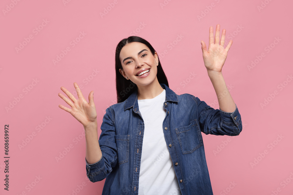 Happy woman giving high five with both hands on pink background Stock ...