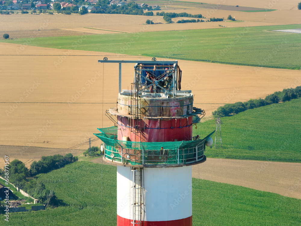Risky maintenance work at the top of a 100 meter high power plant ...