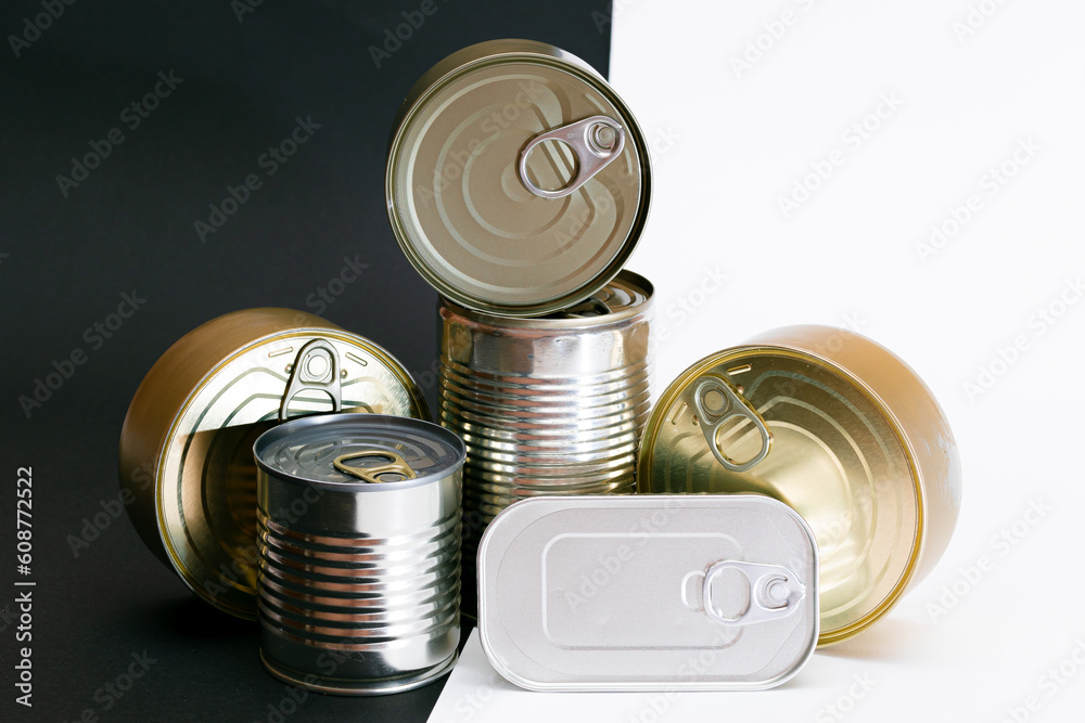 A Group of Stacked Tin Cans with Blank Edges on Split Black and White ...