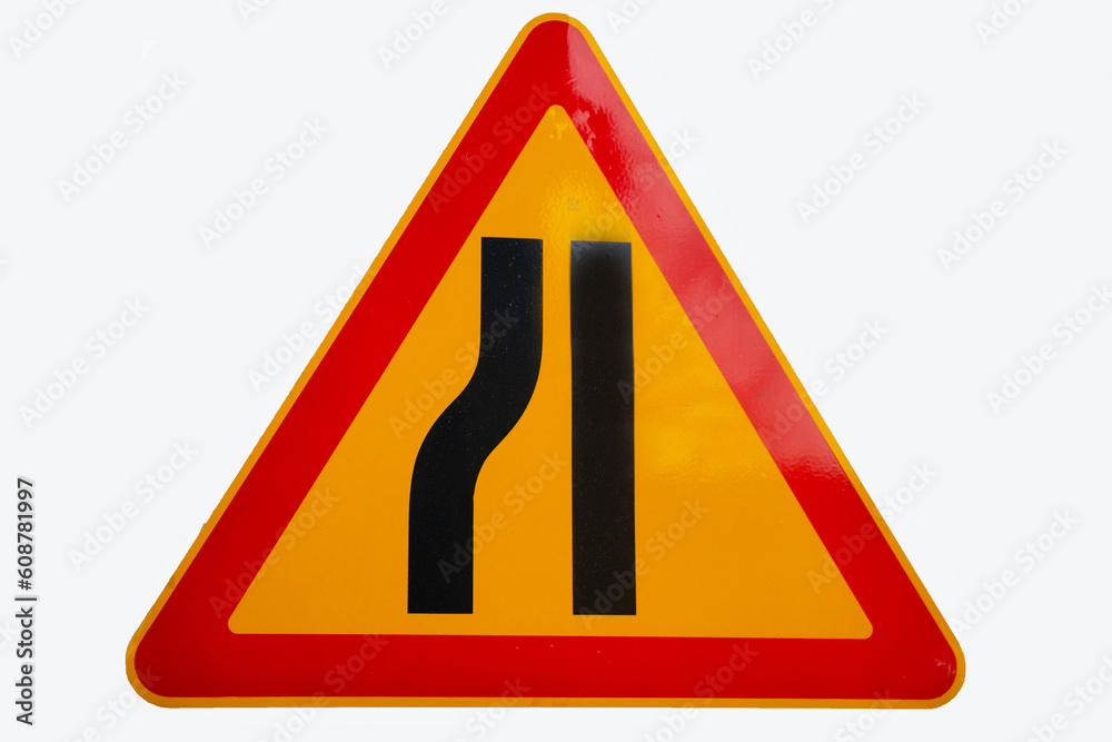 road sign warning of the narrowing of the road ahead. A sign with an ...