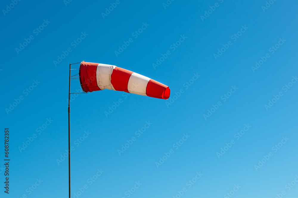 A windsock (also called a wind cone) shows the wind direction at the ...