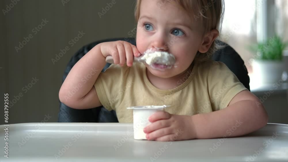 Young Kid Eating Blend Mashed Feed Sitting in High Chair. Baby Weaning ...