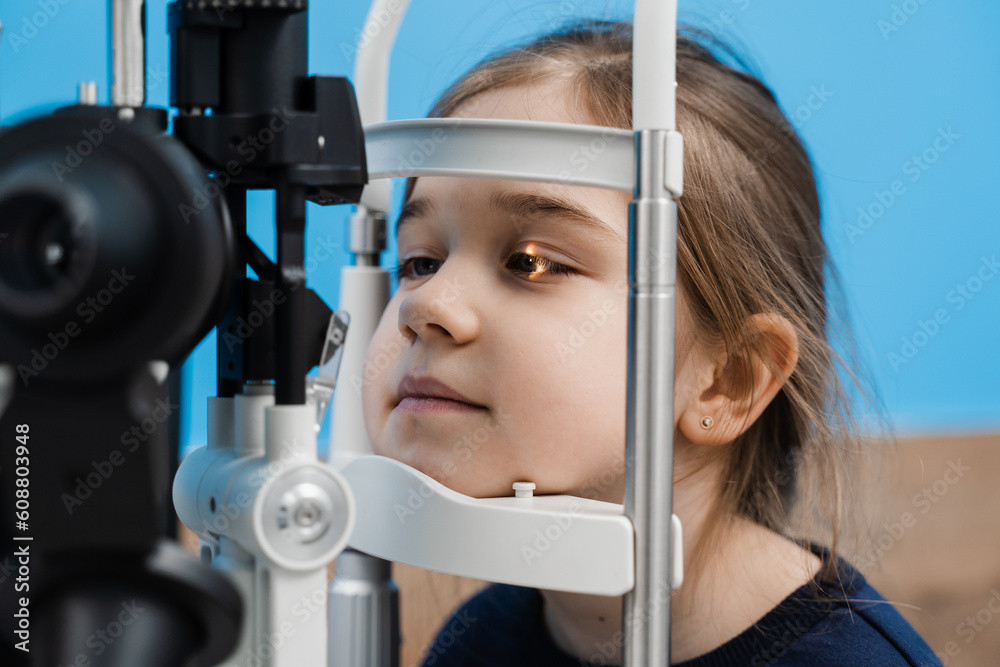 Pediatric ophthalmologist with slit lamp examines eyes and cornea of ... Pediatric ophthalmologist with slit lamp examines eyes and cornea of ...