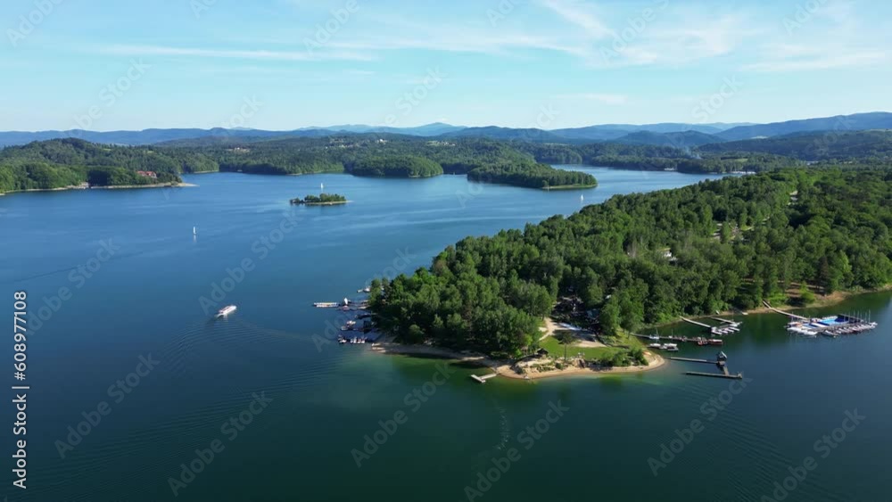 Floating sailboats and passenger ship carrying people on Solina lake in ...