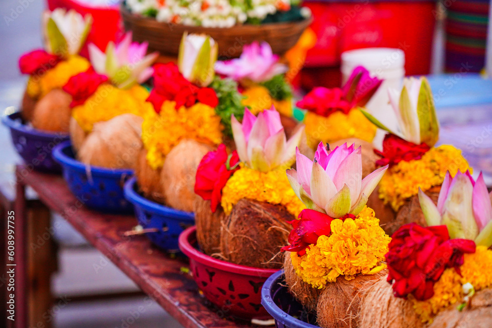 Pealed coconuts, lotus , rose and other flowers prepared for pooja ...