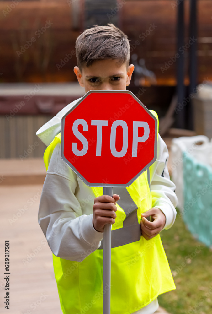 A boy is holding a stop sign. Red stop sign, symbol of detention ...