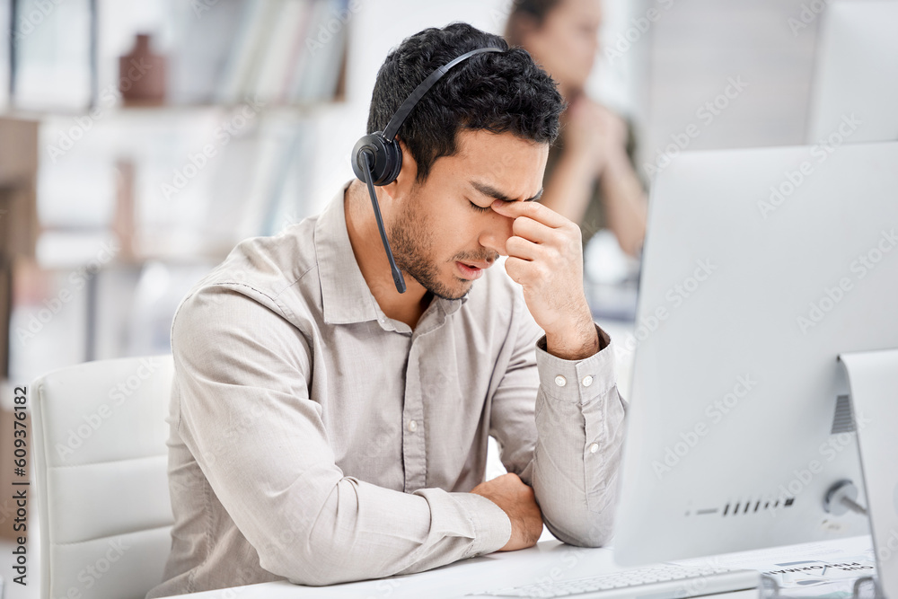 Mental health, man with headache and headset at his desk with computer ...
