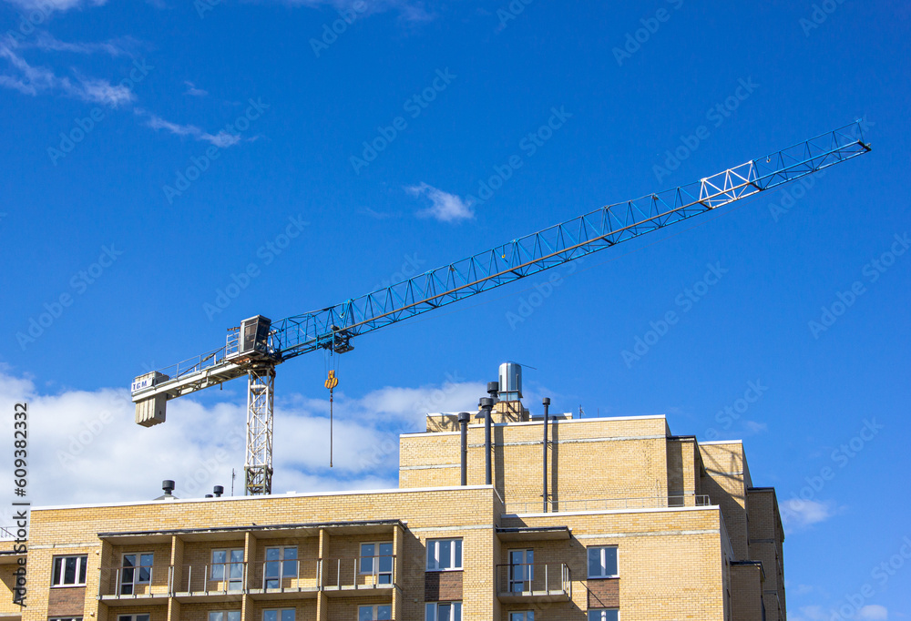 Construction tower crane and apartment building under construction ...